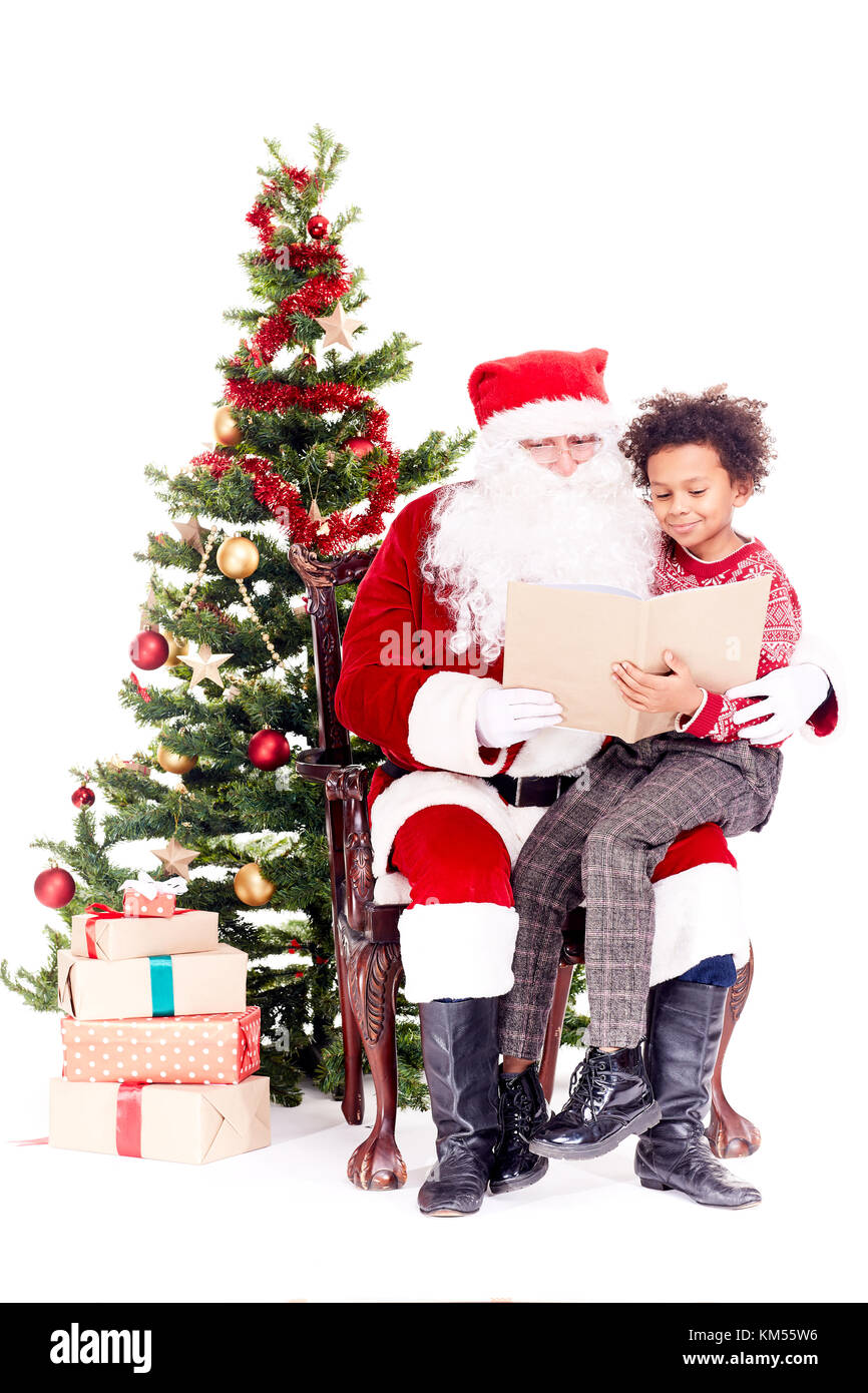 Santa reading Christmas story for kid Stock Photo - Alamy