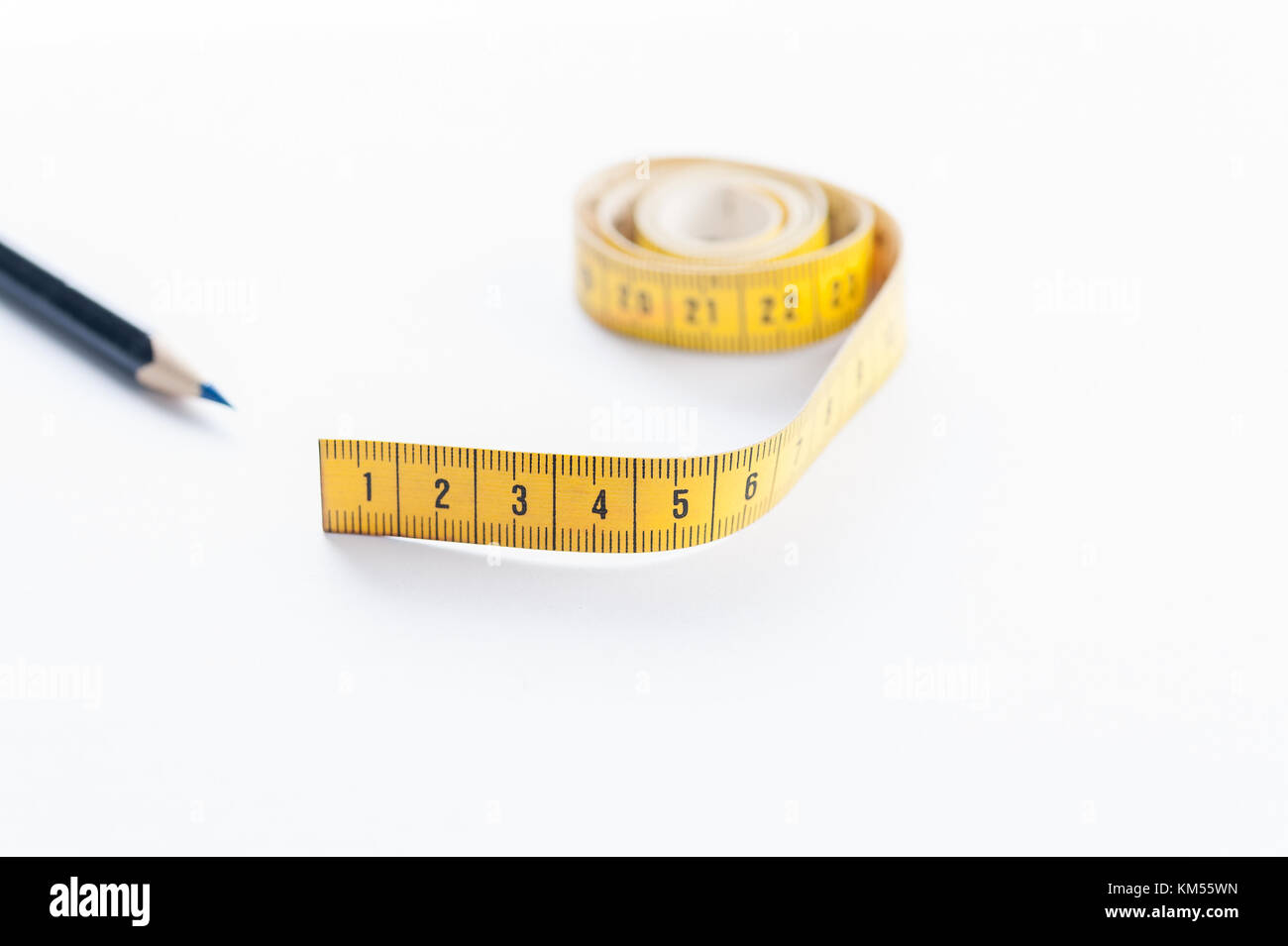tape measure and pen on white surface Stock Photo - Alamy