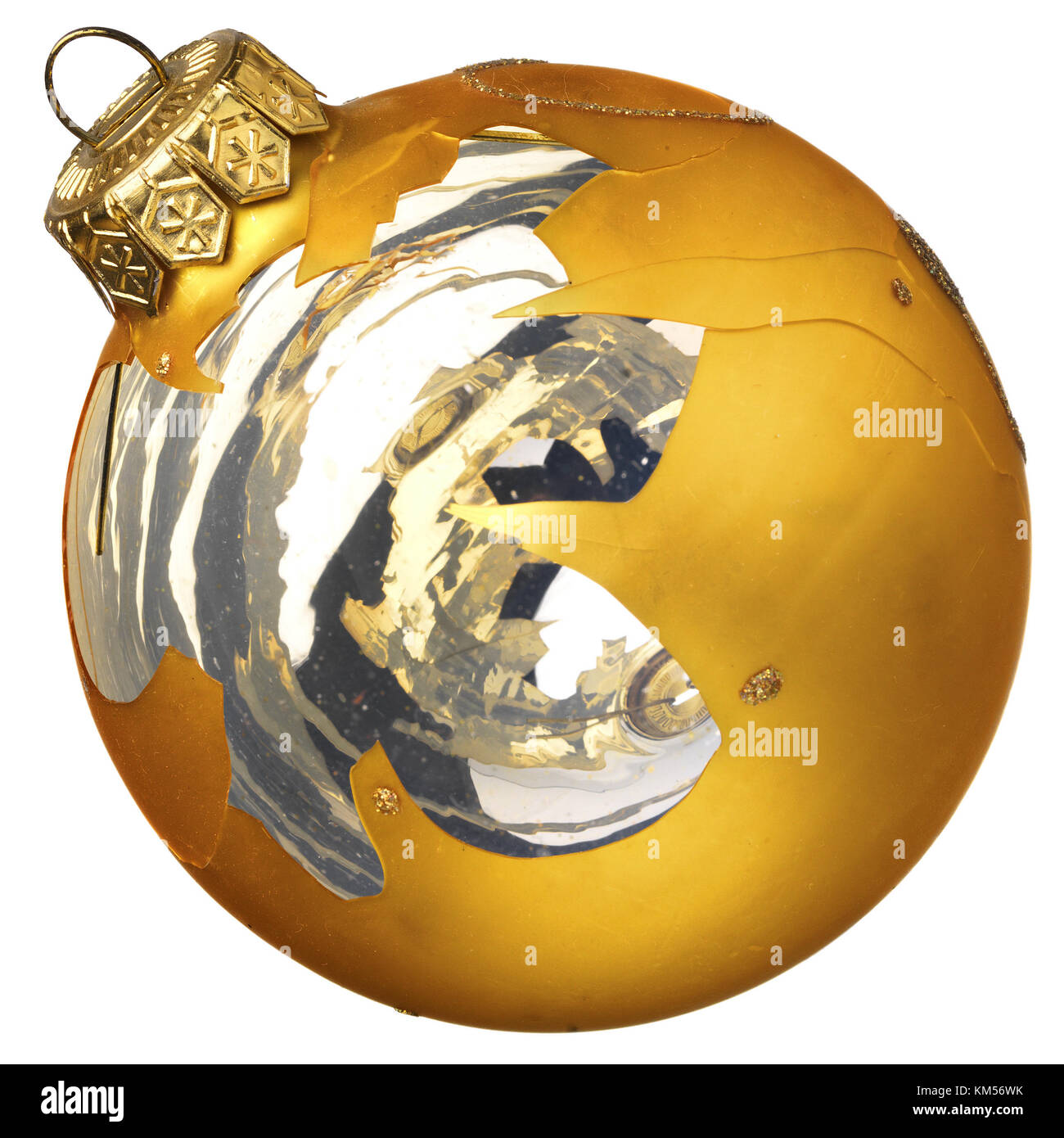 Accidentally broken golden Christmas glass ball isolated on a white ...