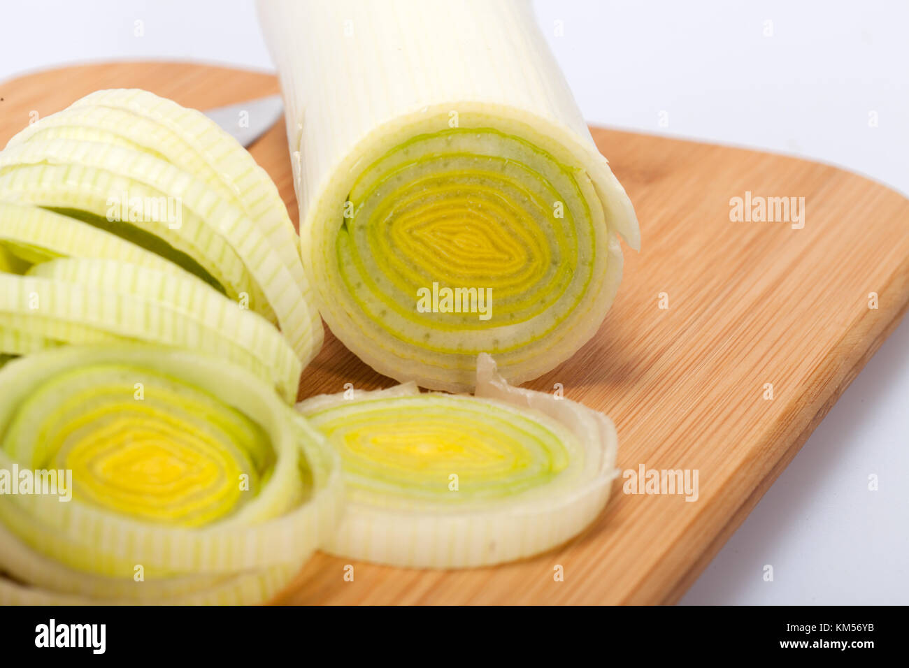 Sliced Leeks on woden table Stock Photo - Alamy