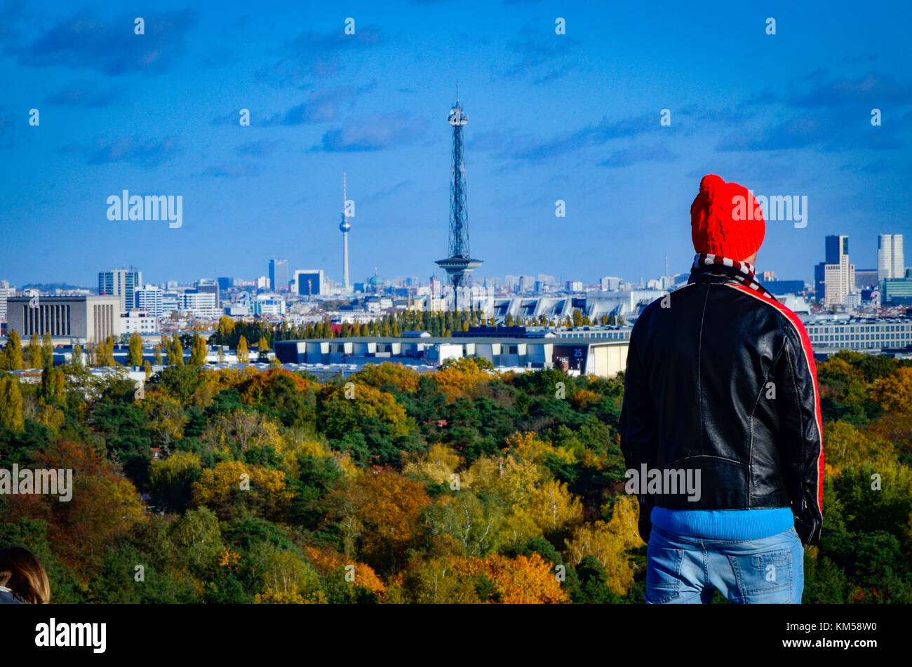 Men in front of Berlin Panorama in autumn. Rear shot of creative guy ...