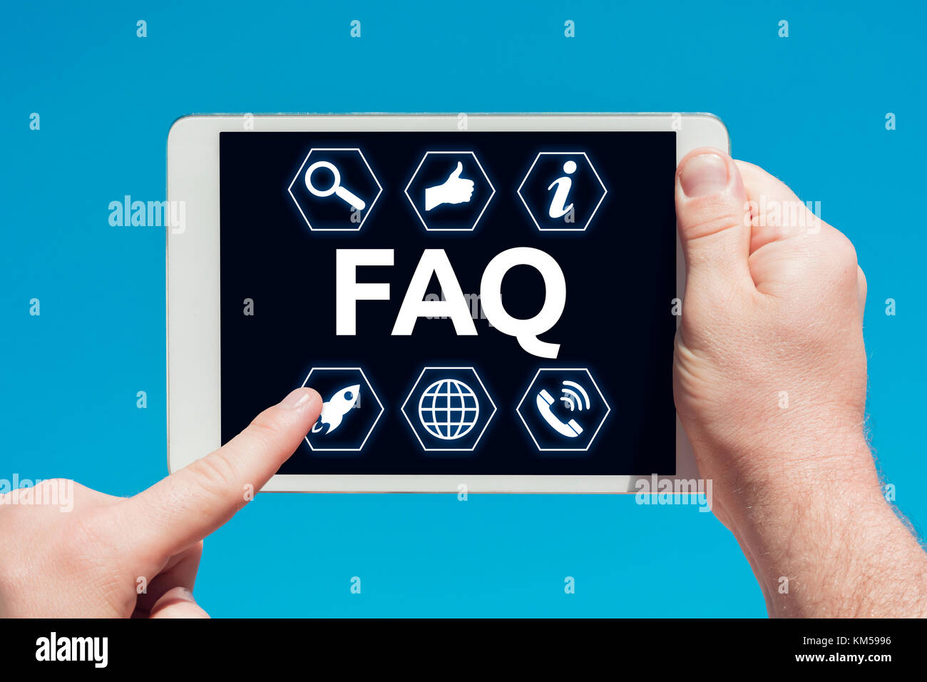 Man holding a tablet device showing frequently asked questions icons ...
