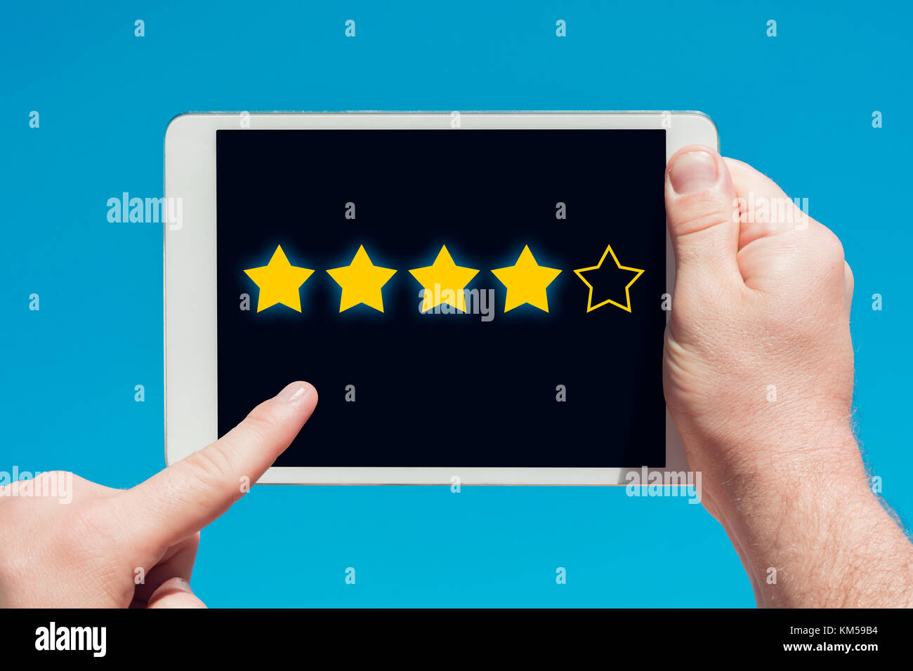 Man holding a tablet device and rating stars as evaluation, ranking ...