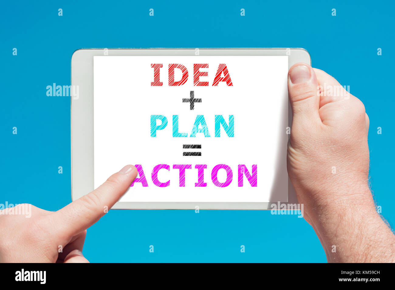 Man holding a tablet device with text idea plan action on the screen ...