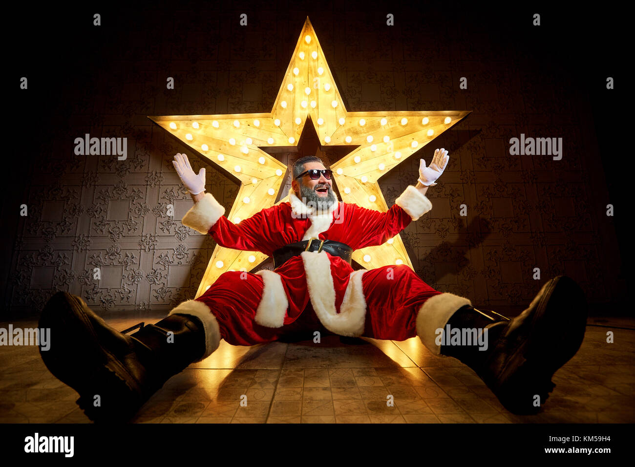 Happy Santa sings into the microphone against the backdrop of a Stock ...