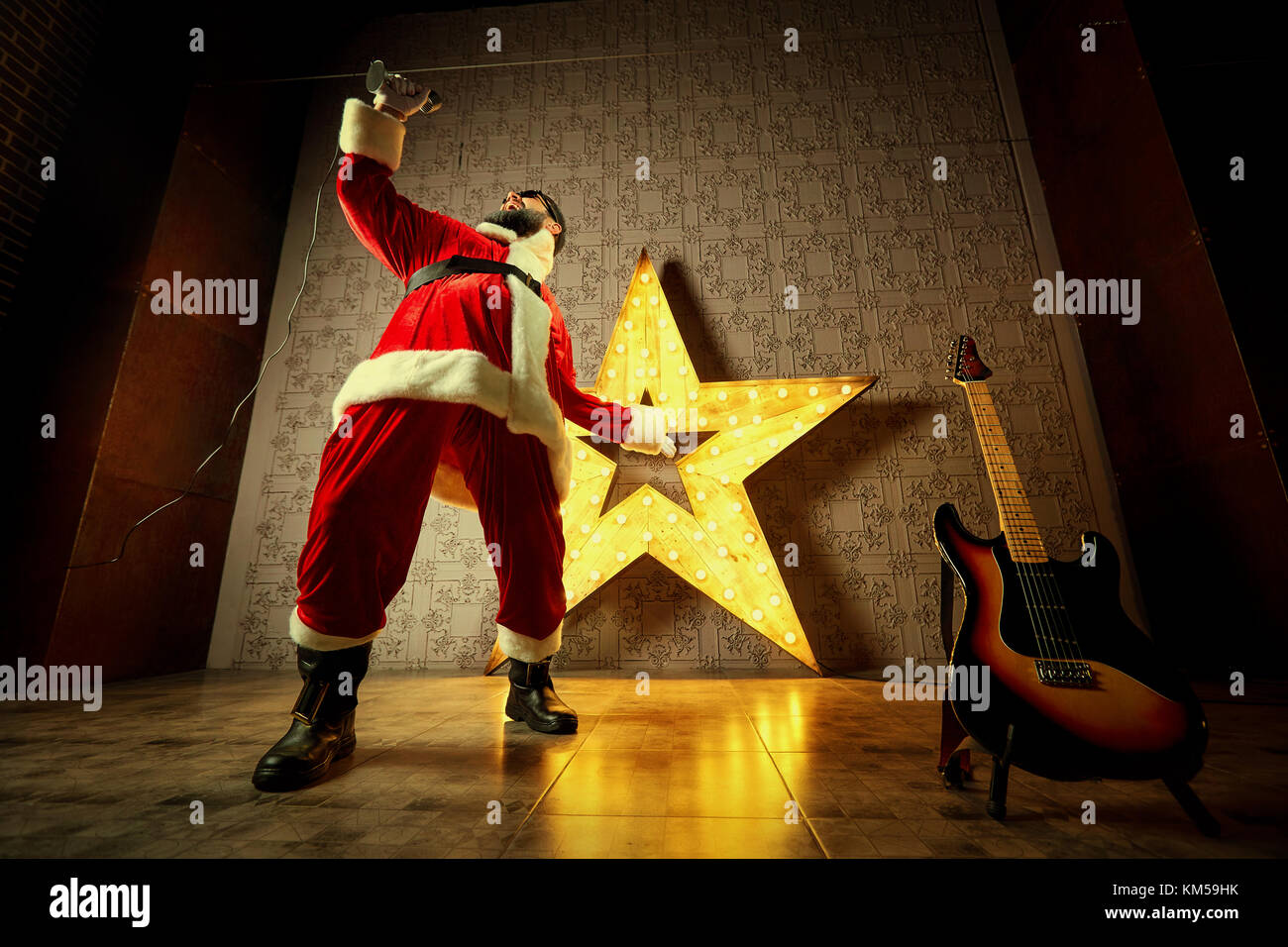 Happy Santa sings into the microphone against the backdrop of a Stock ...