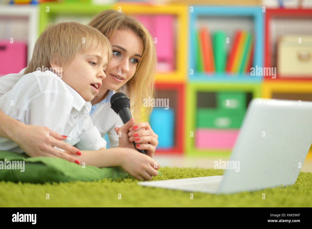 Mother and son singing karaoke Stock Photo - Alamy