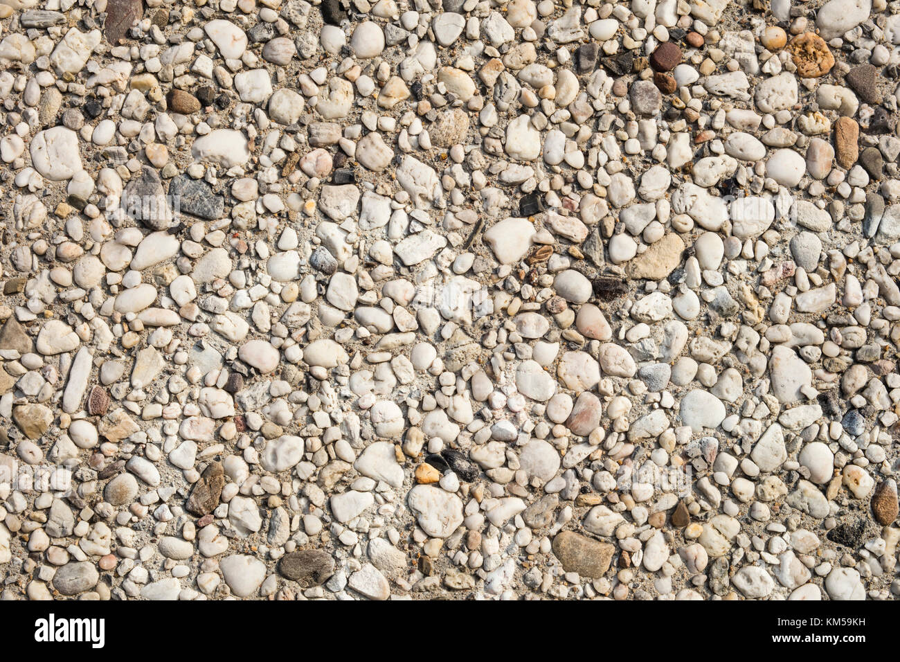 Closeup of pebble stones texture on a sunny day Stock Photo - Alamy