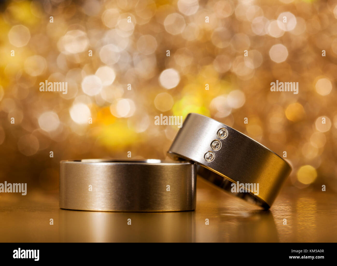 Pair of wedding rings, closeup, sparkling bokeh background Stock Photo - Alamy