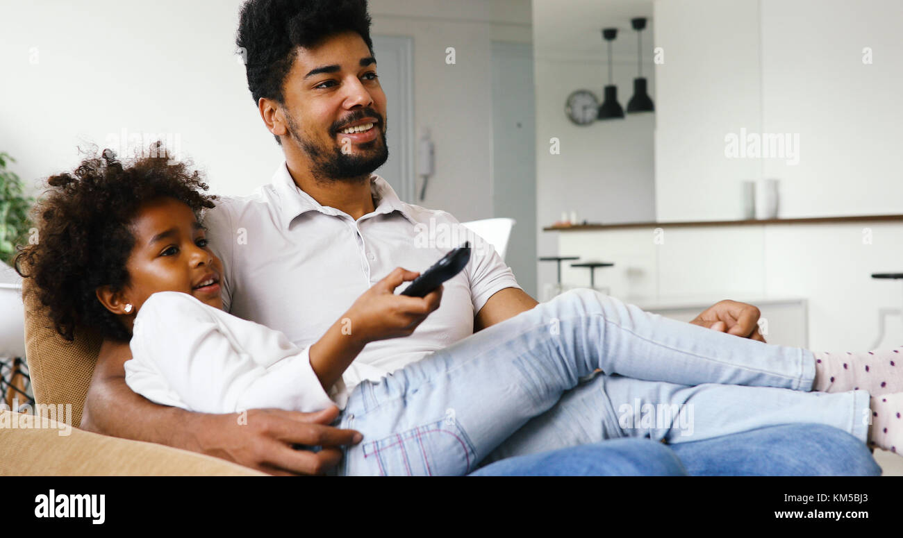 happy father and daughter and watching tv at home Stock Photo - Alamy