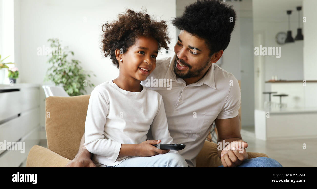 happy father and daughter and watching tv at home Stock Photo - Alamy