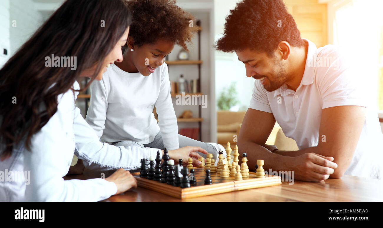Happy family playing chess together at home Stock Photo - Alamy