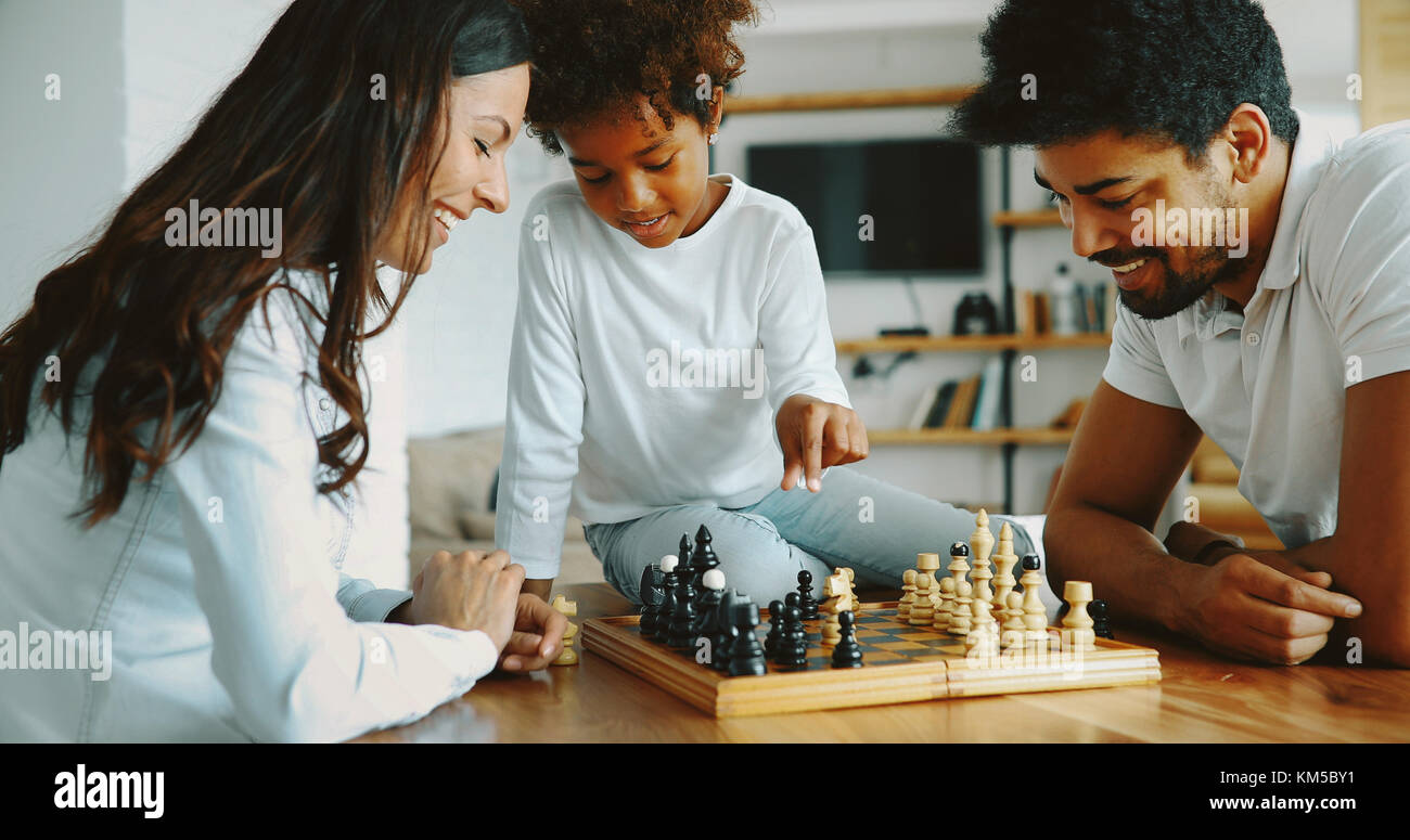 Happy family playing chess together at home Stock Photo - Alamy