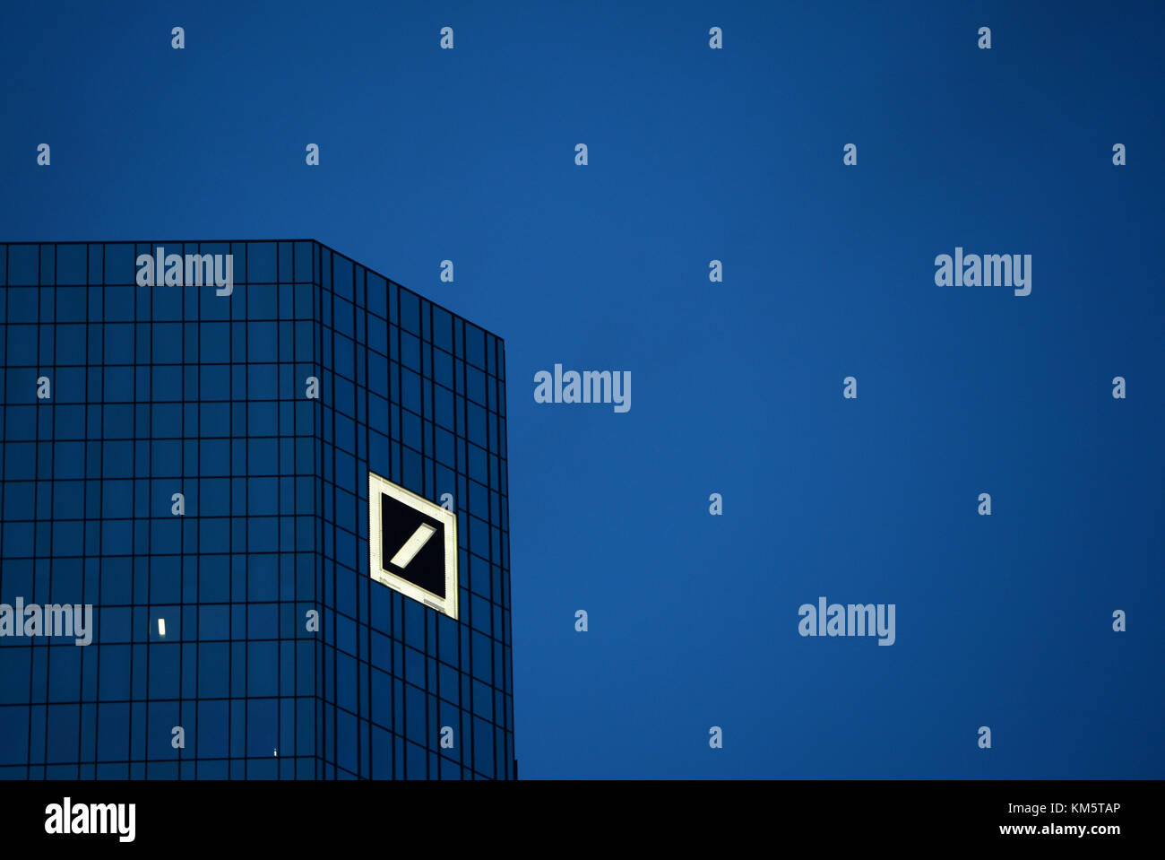 ARCHIVE - The logo of the Deutsche Bank glows on the facade of the ...