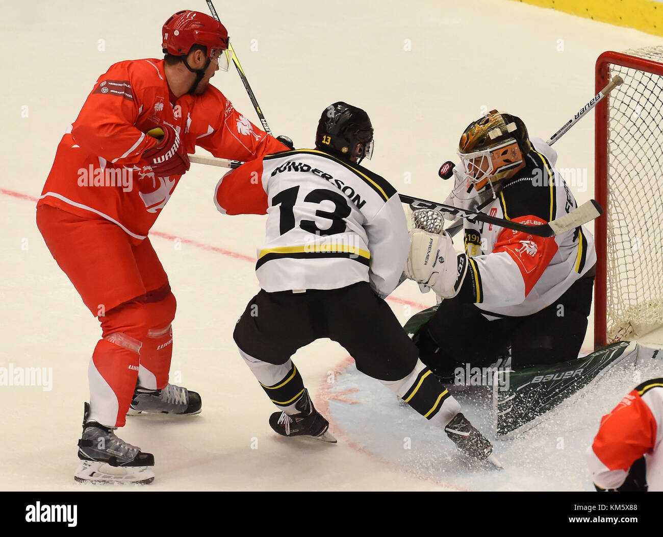 L-R Bohumil Jank of Trinec, Ryan Gunderson and goalkeeper Linus ...