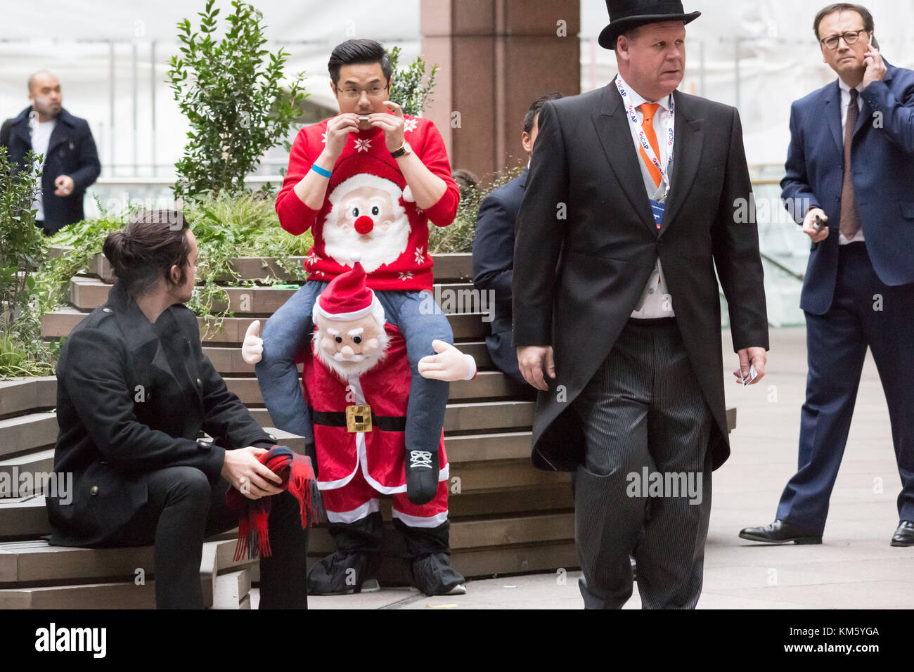 London, UK. 5th Dec, 2017. City traders arrive in fancy dress ready to ...