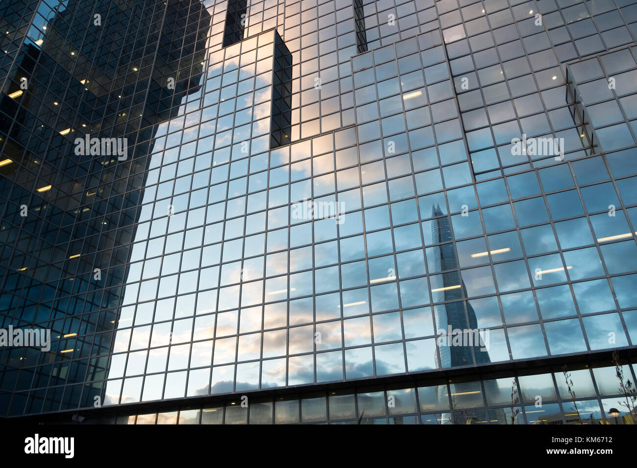 Clouds in the sky reflected in the square glass panels of the Northern ...