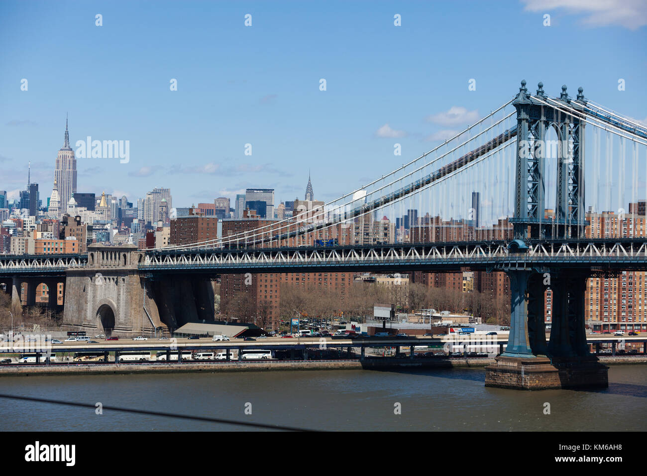 Classic view of the Brooklyn Bridge and Empire State Building in New ...