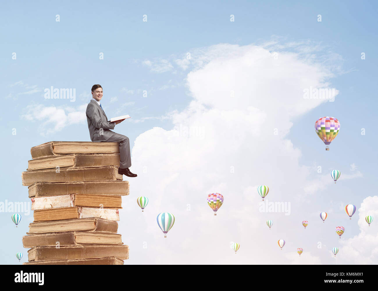 Man student reading book and aerostats flying around in air Stock Photo ...