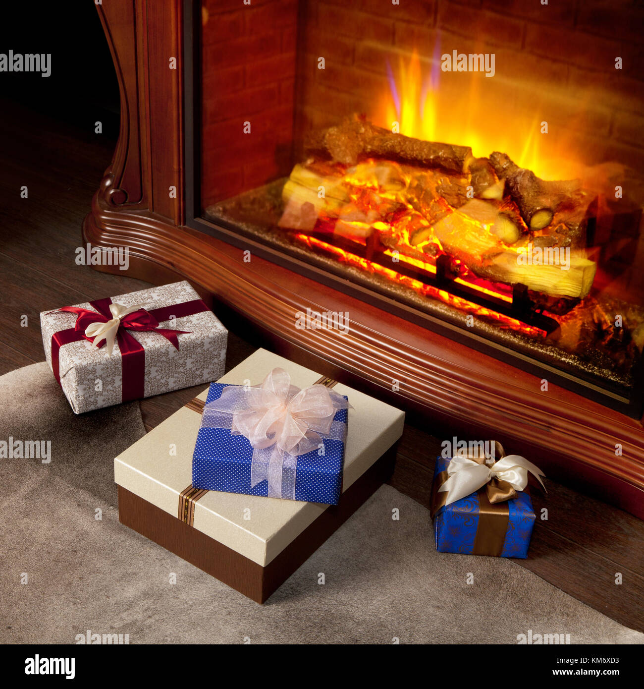 Christmas gift boxes in the interior with fireplace Stock Photo - Alamy