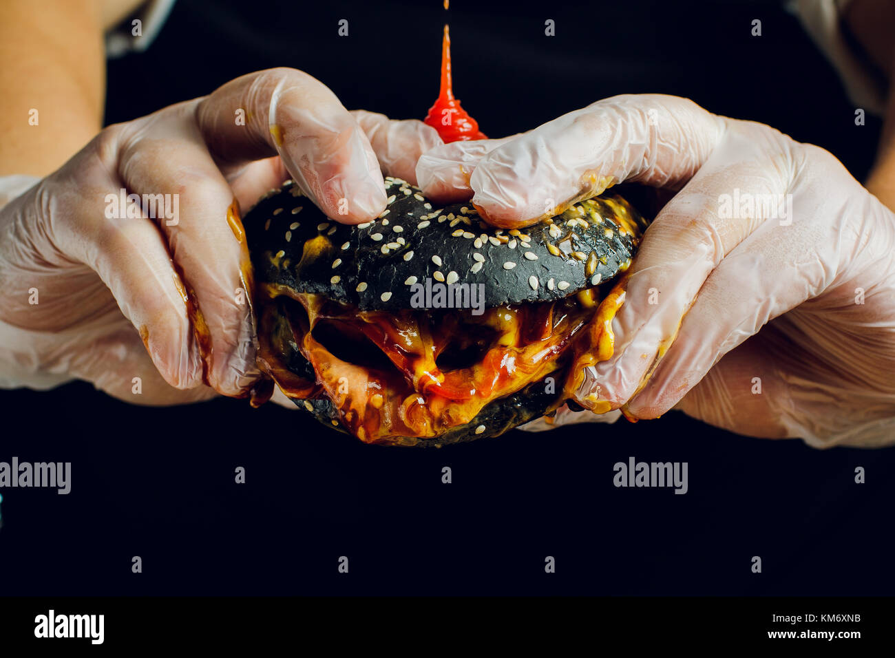 fresh tasty burger on black background macro Stock Photo - Alamy