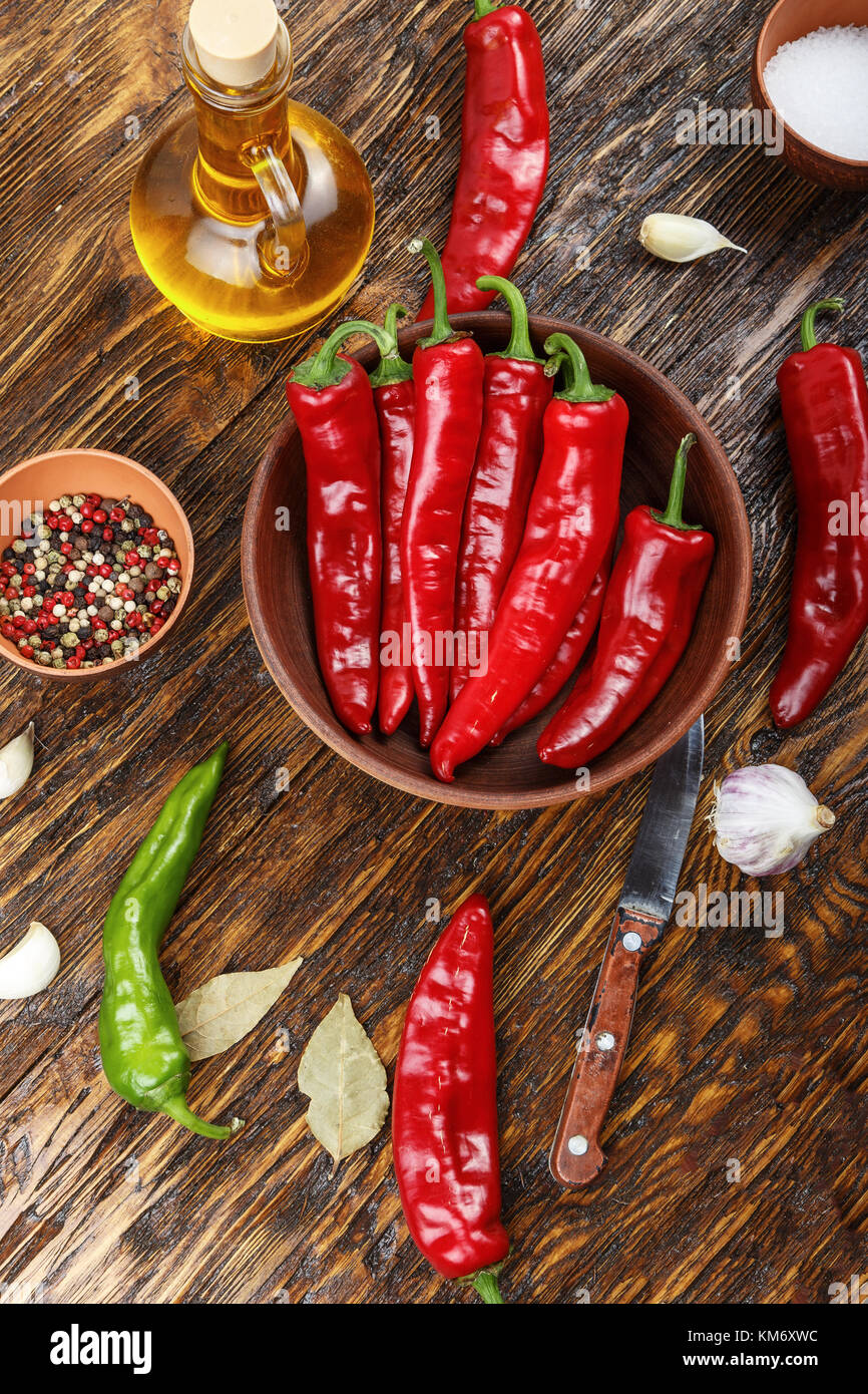 red pepper in a clay plate on dark wooden surface Stock Photo - Alamy