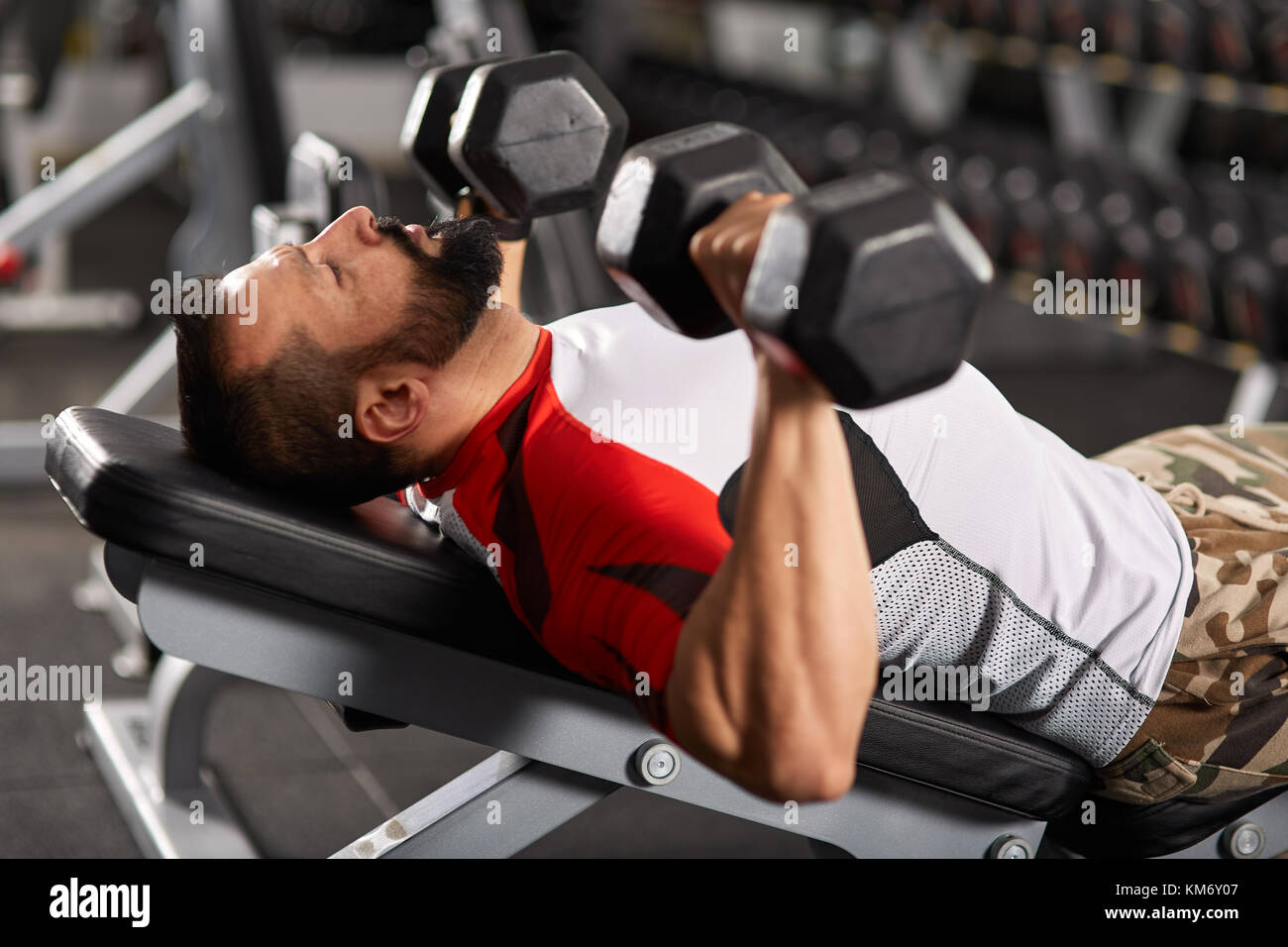 Man doing chest workout at inclined bench with dumbbells Stock Photo ...