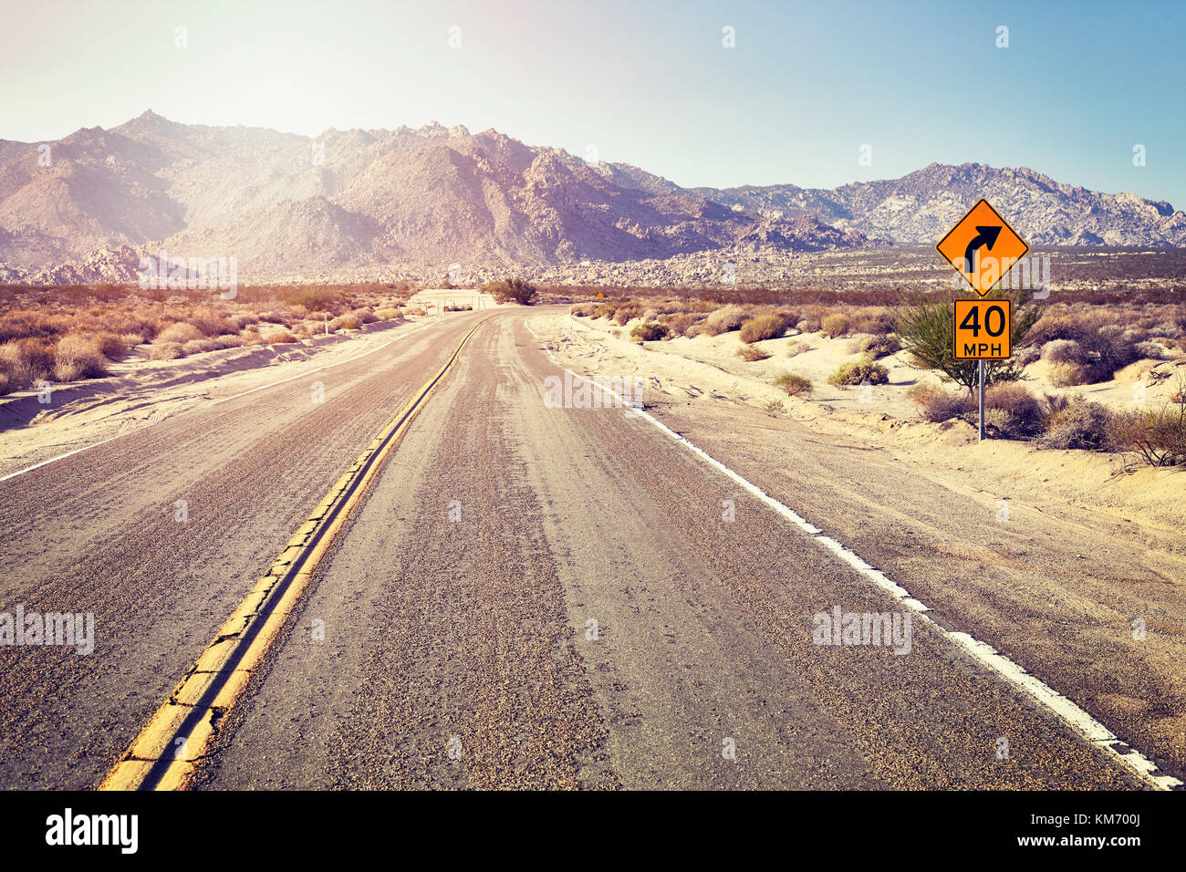 Desert highway with speed limit sign, color toned picture, travel ...