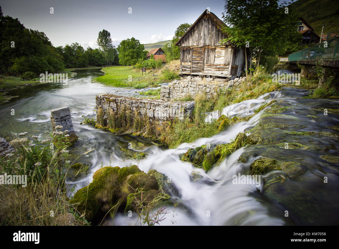 Old water mill with fast flowing water at the source of the River Gacka ...