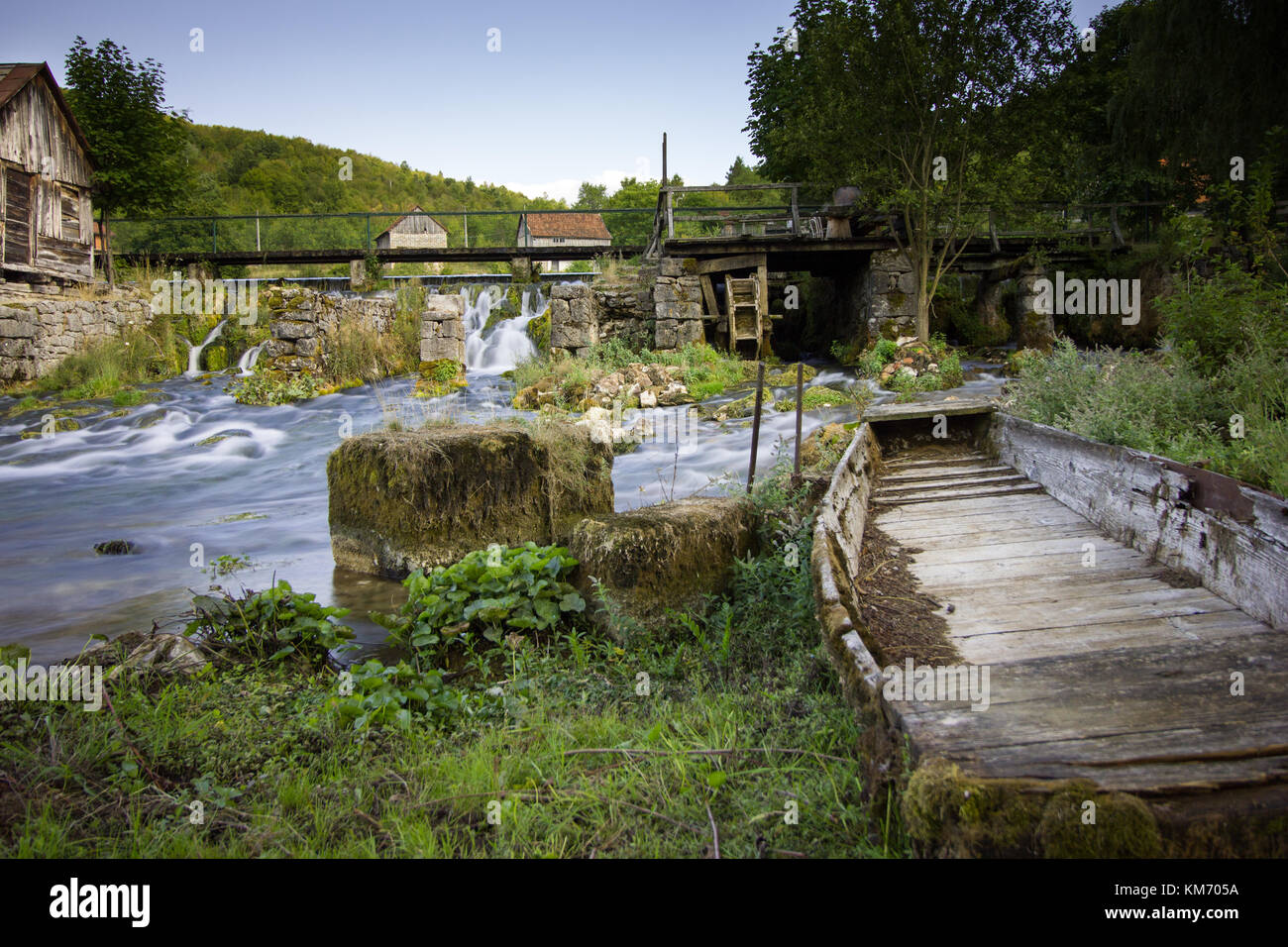 Old water mill with fast flowing water at the source of the River Gacka ...