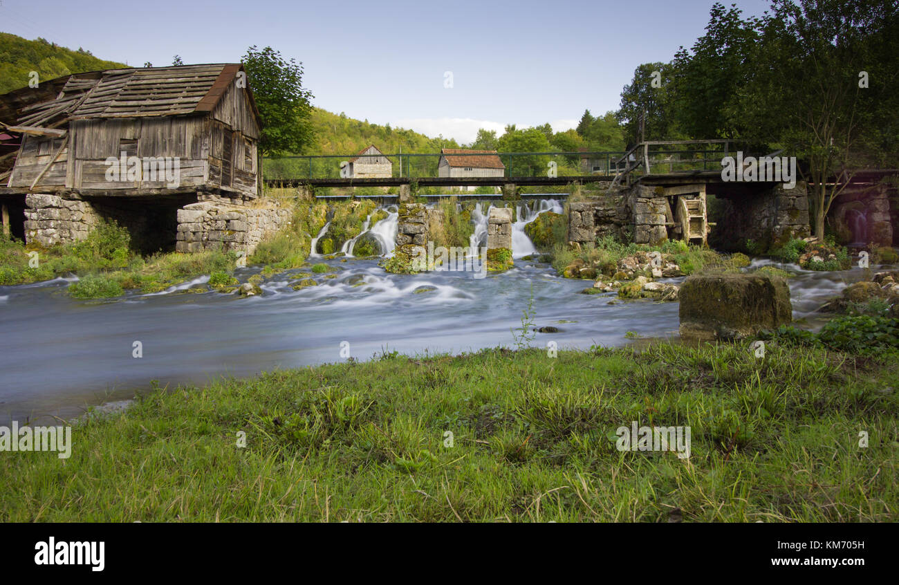 Old water mill with fast flowing water at the source of the River Gacka ...