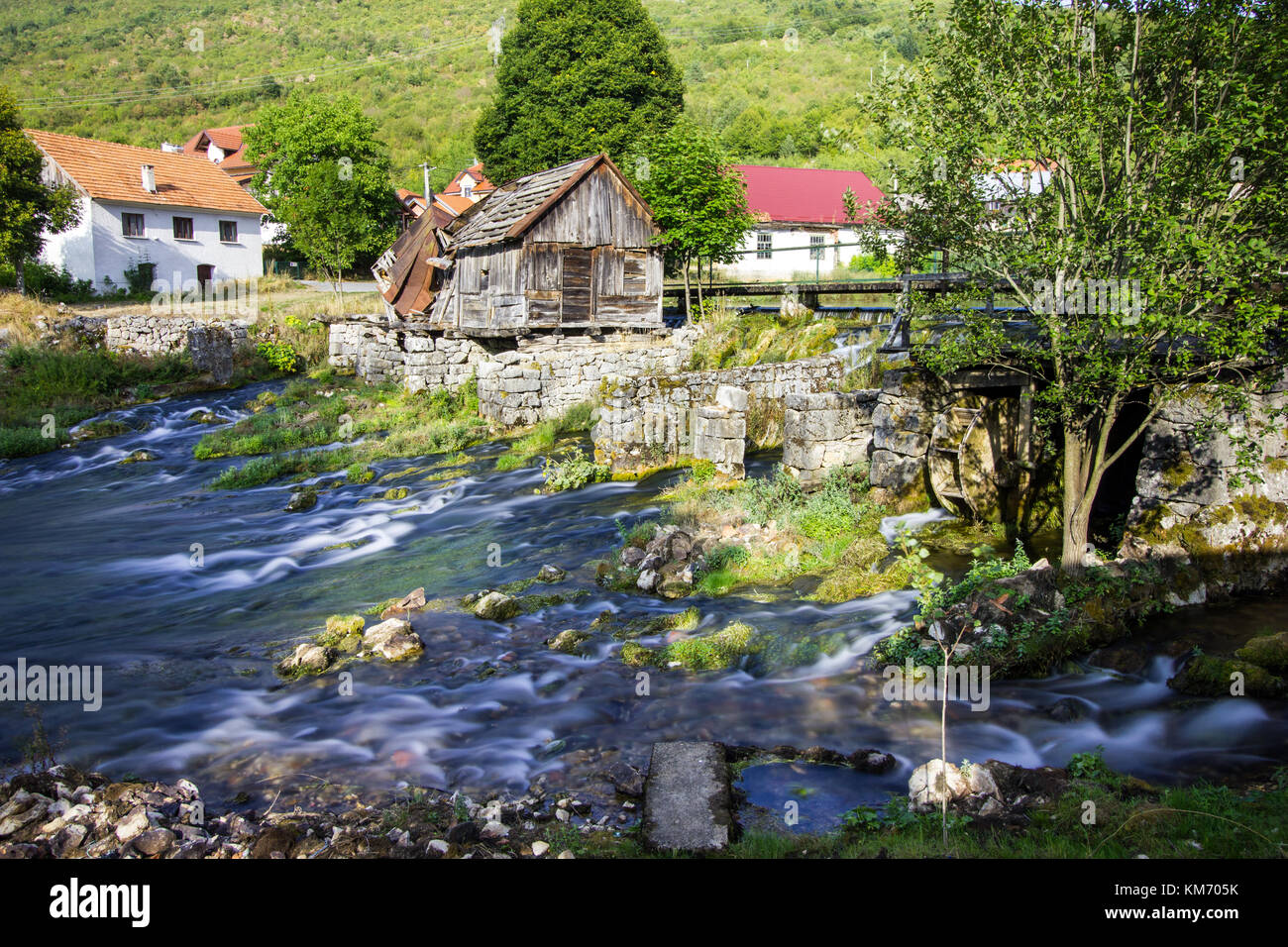 Old water mill with fast flowing water at the source of the River Gacka ...
