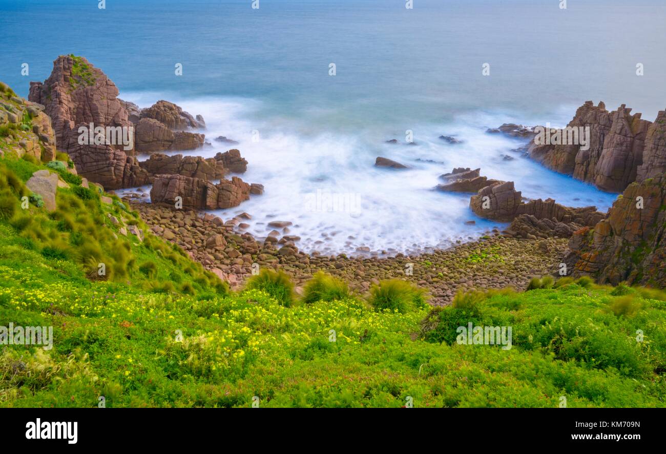 A dramatic view of a low beach covered in pebble shaped rocks and ...
