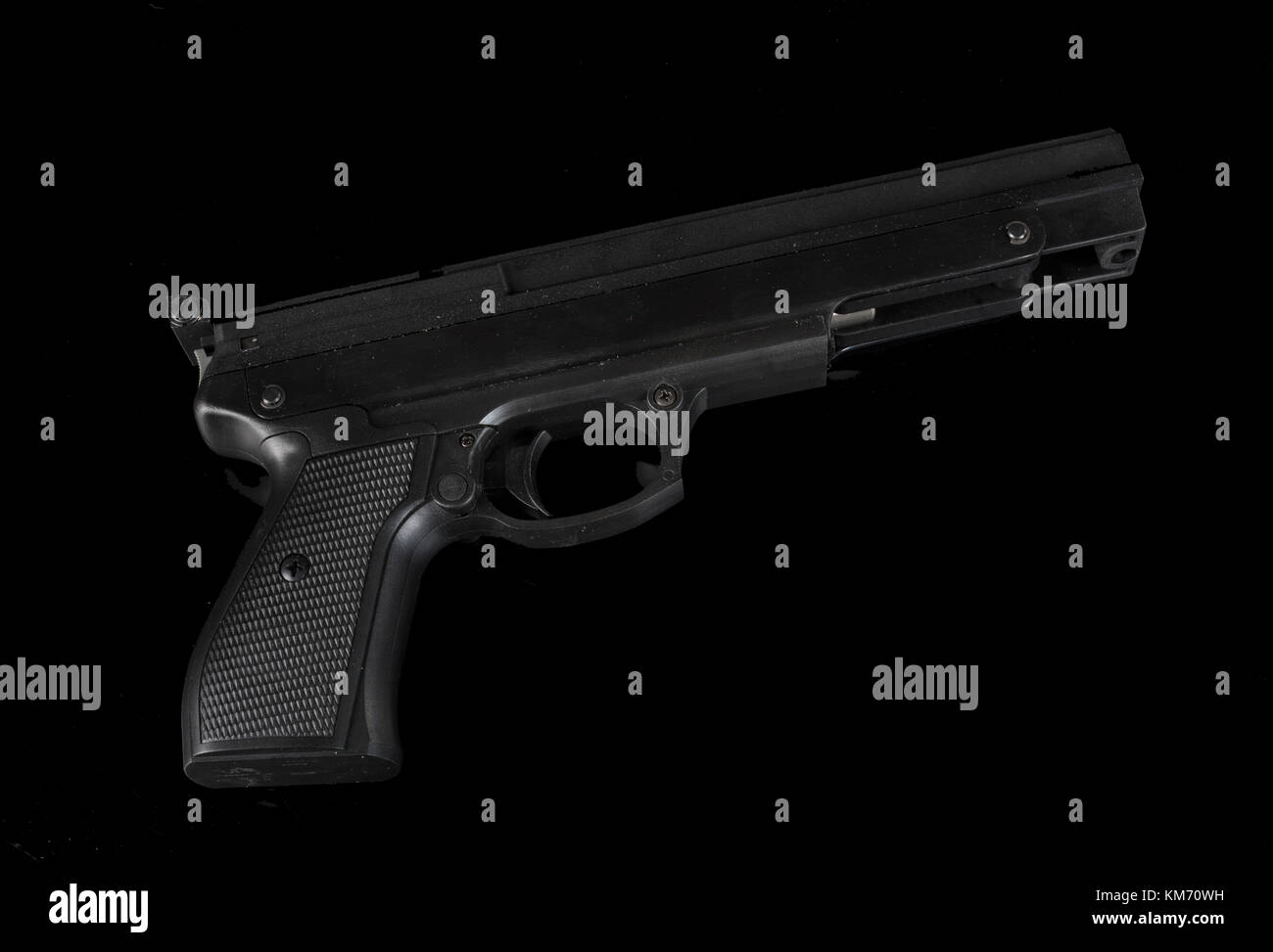 black gun in front of black background Stock Photo - Alamy