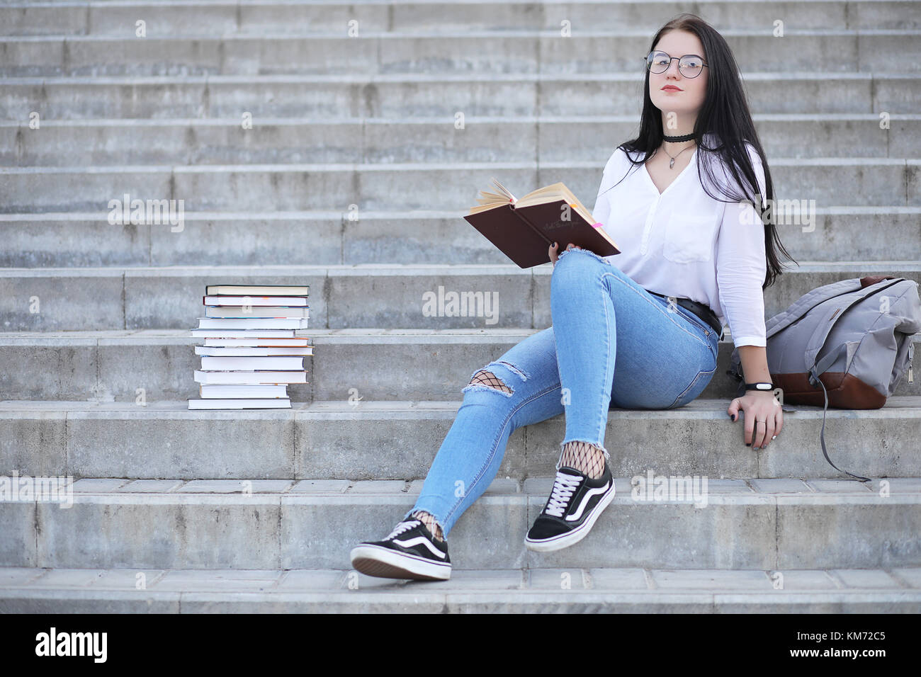 Girl student on the street with books Stock Photo - Alamy