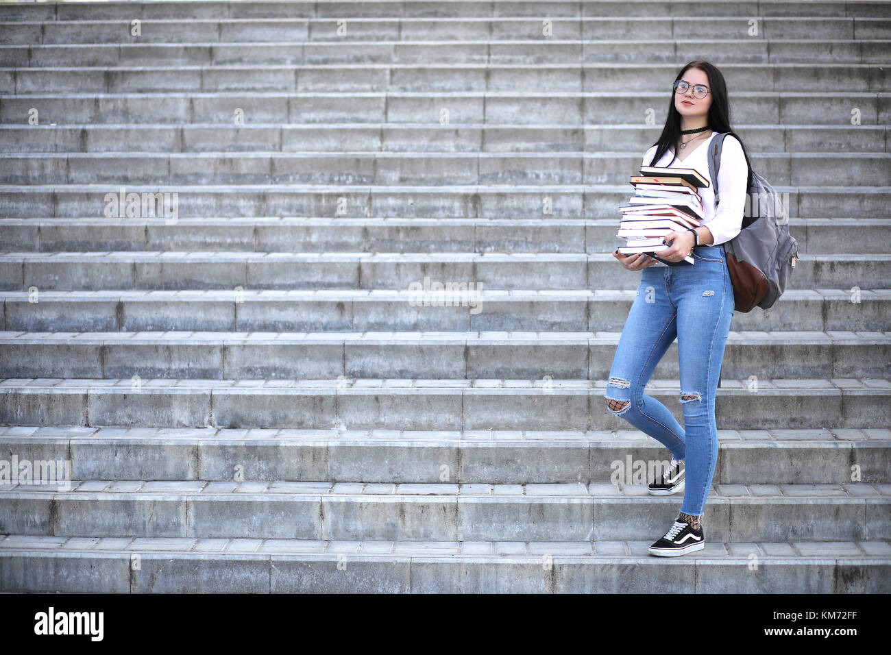 Girl student on the street with books Stock Photo - Alamy