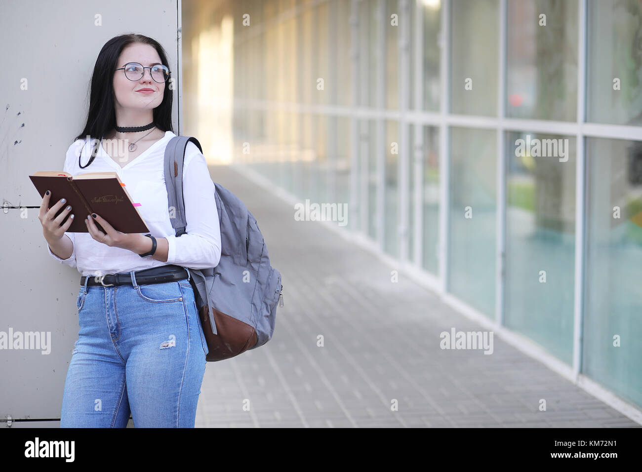 Girl student on the street with books Stock Photo - Alamy