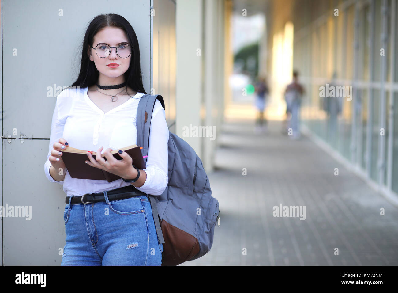 Girl student on the street with books Stock Photo - Alamy