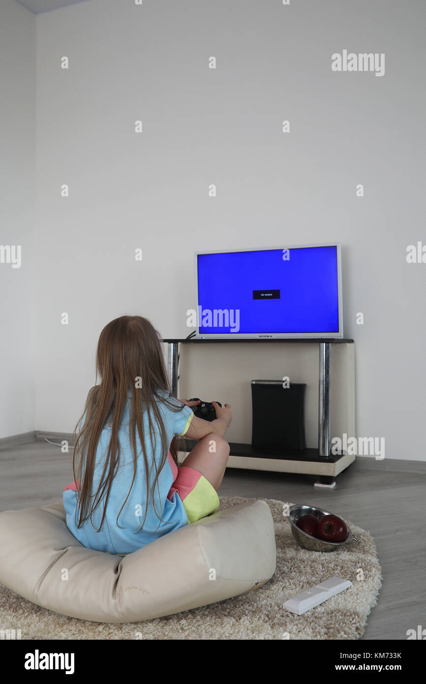 Young girl playing in front of the TV Stock Photo - Alamy