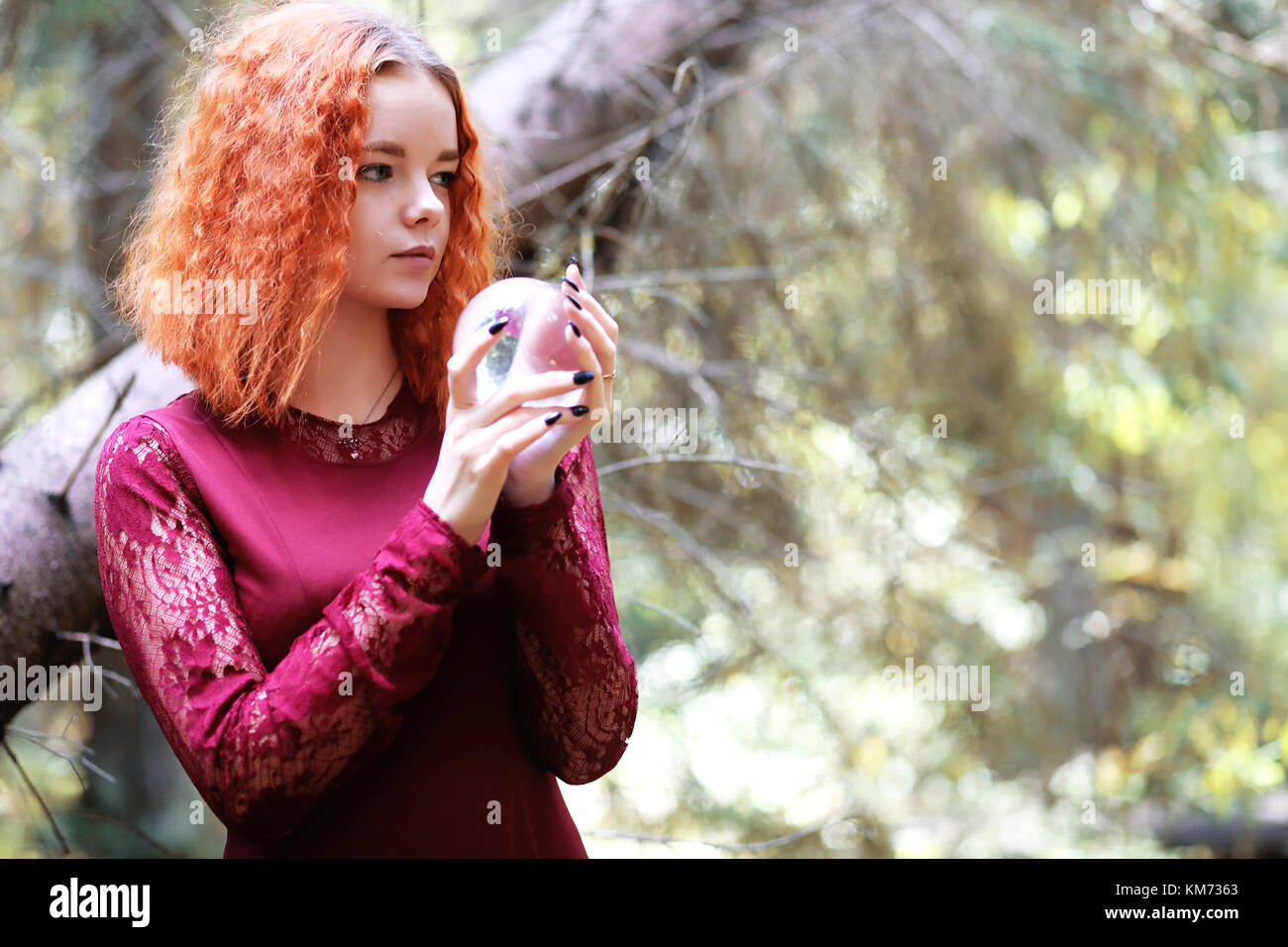 The red-haired witch holds a ritual with a crystal ball Stock Photo - Alamy
