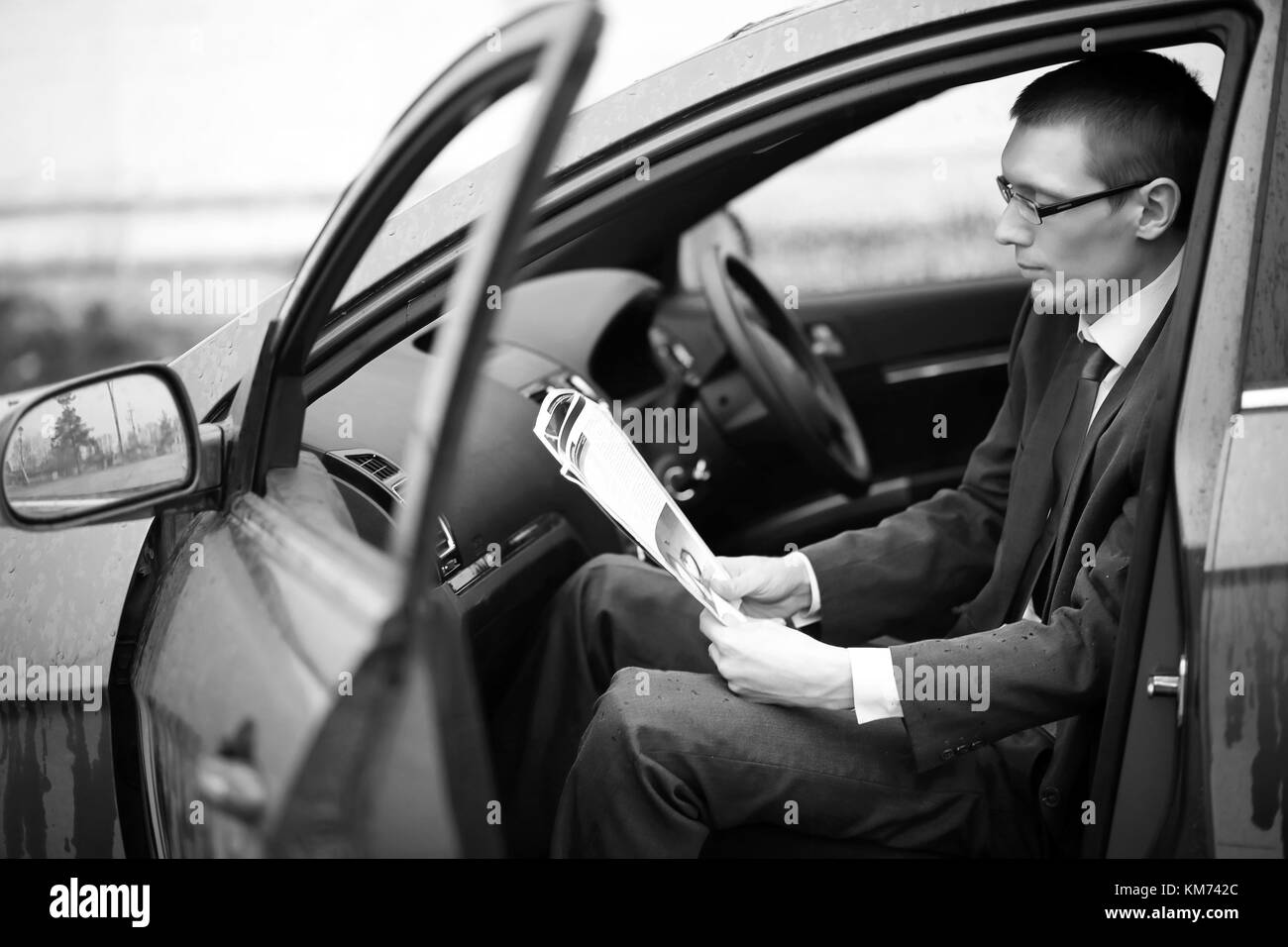 Businessman in a suit in a car Stock Photo - Alamy