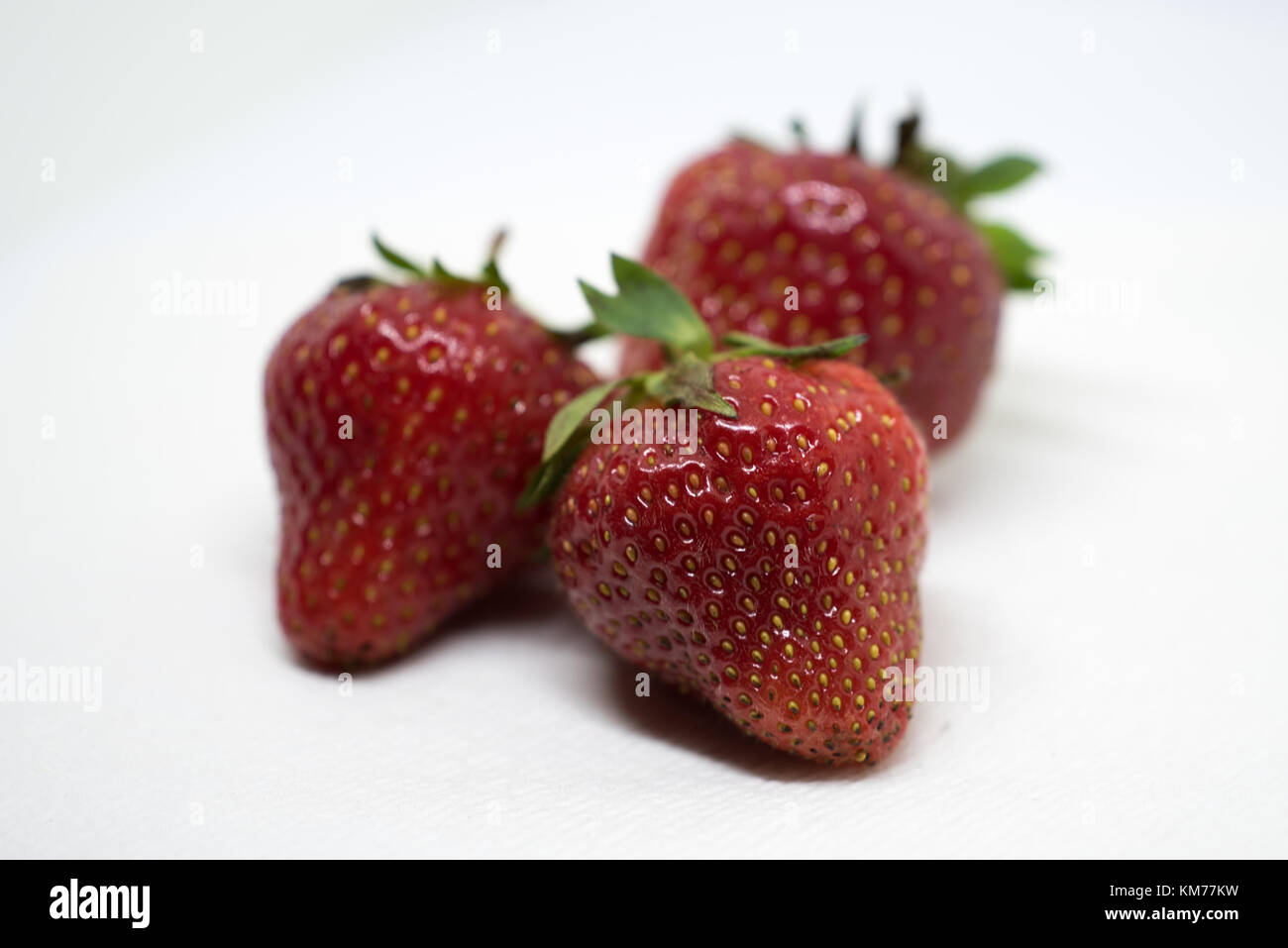 Three Isolated Strawberries Stock Photo - Alamy