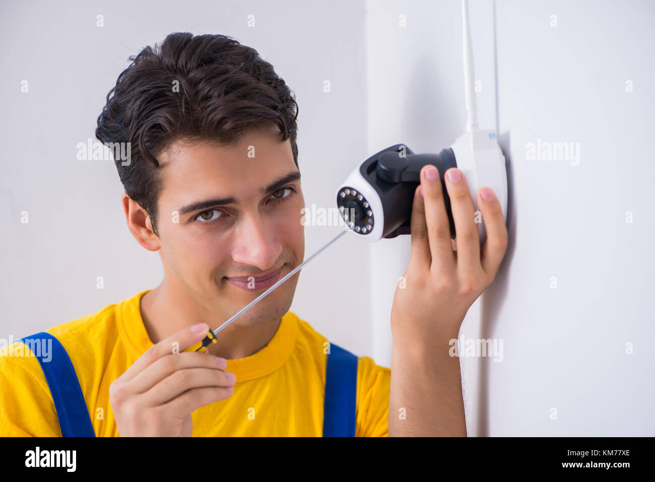 Contractor installing surveillance CCTV cameras in office Stock Photo ...