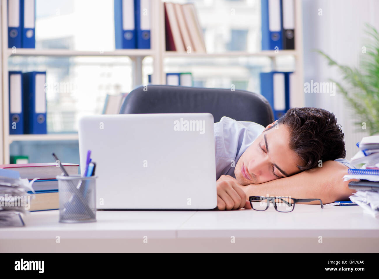 Tired exhausted businessman sitting in the office Stock Photo - Alamy