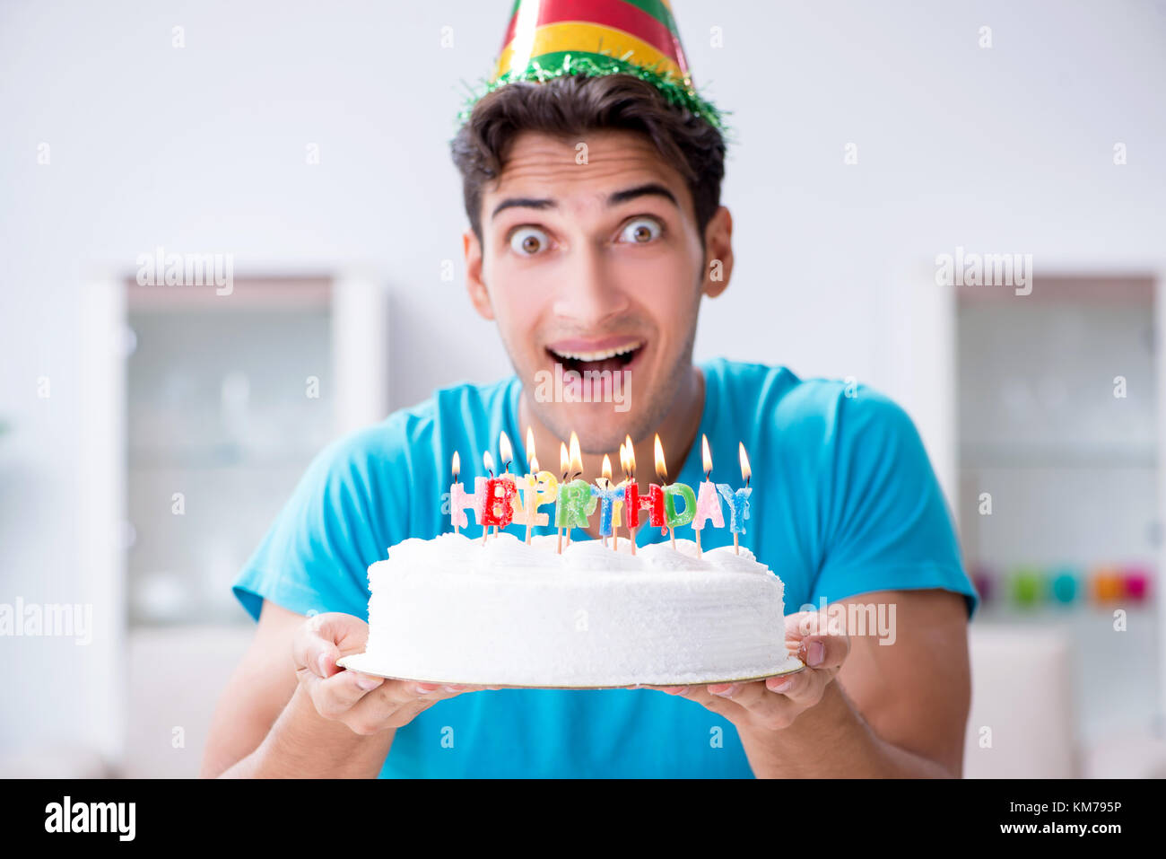 Young man celebrating birthday alone at home Stock Photo - Alamy