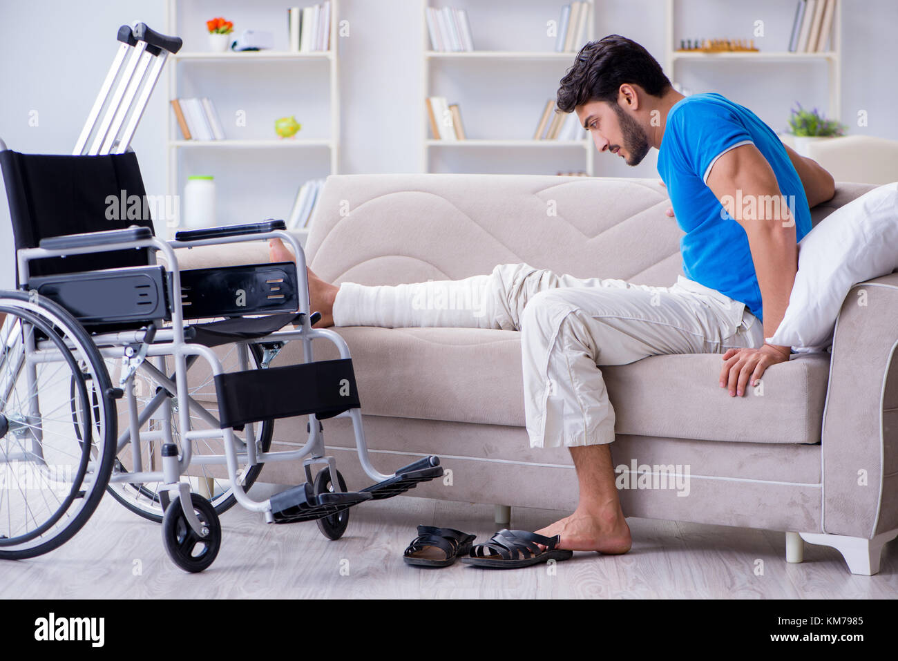 Injured young man recovering at home Stock Photo - Alamy