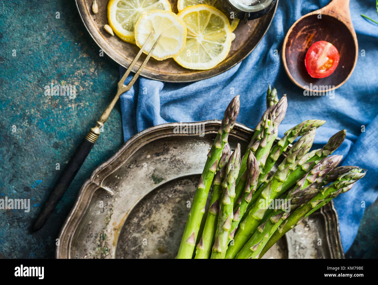 Asparagus cooking preparation on rustic kitchen table, top view, close ...