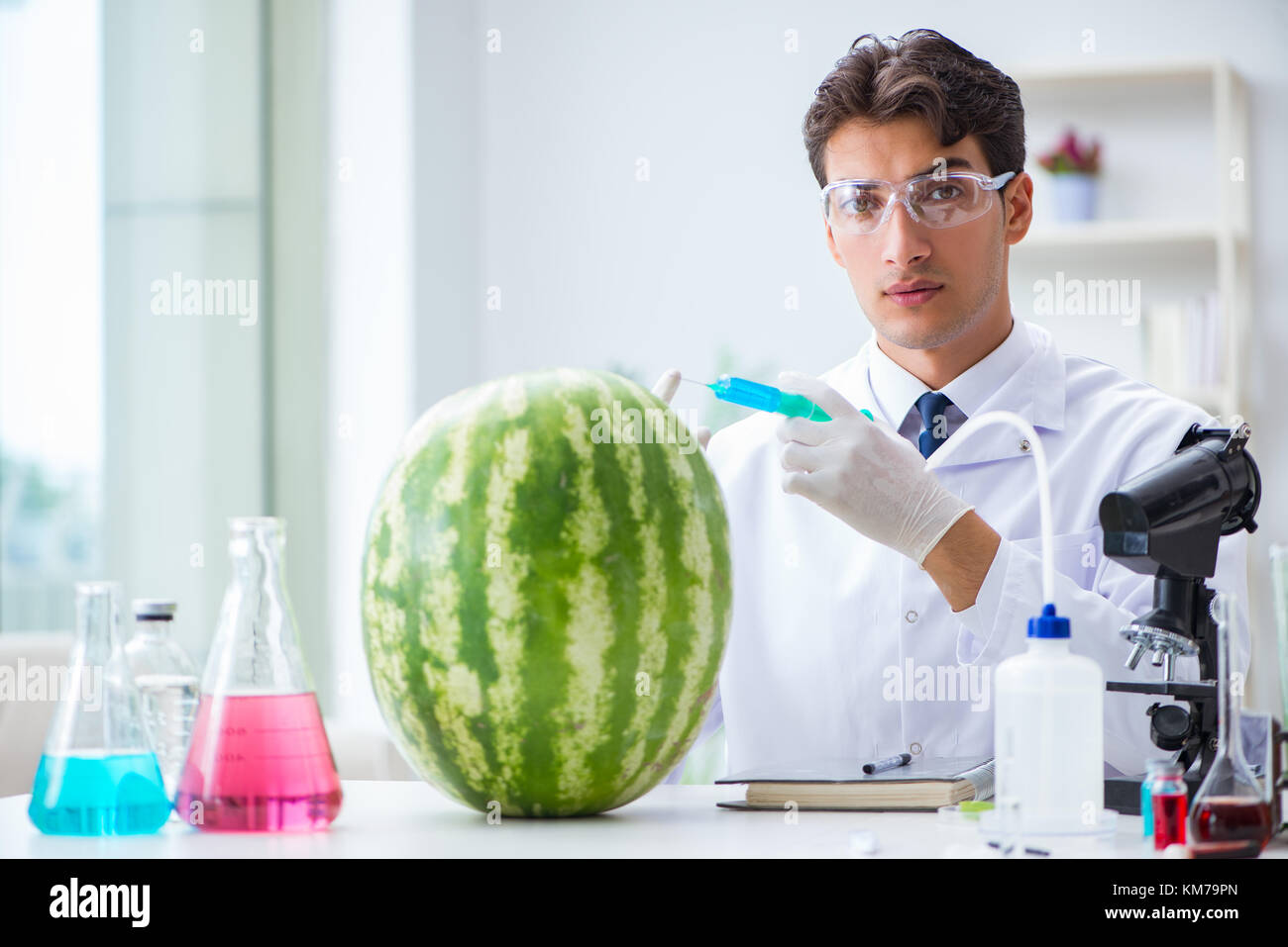 Scientist testing watermelon in lab Stock Photo - Alamy