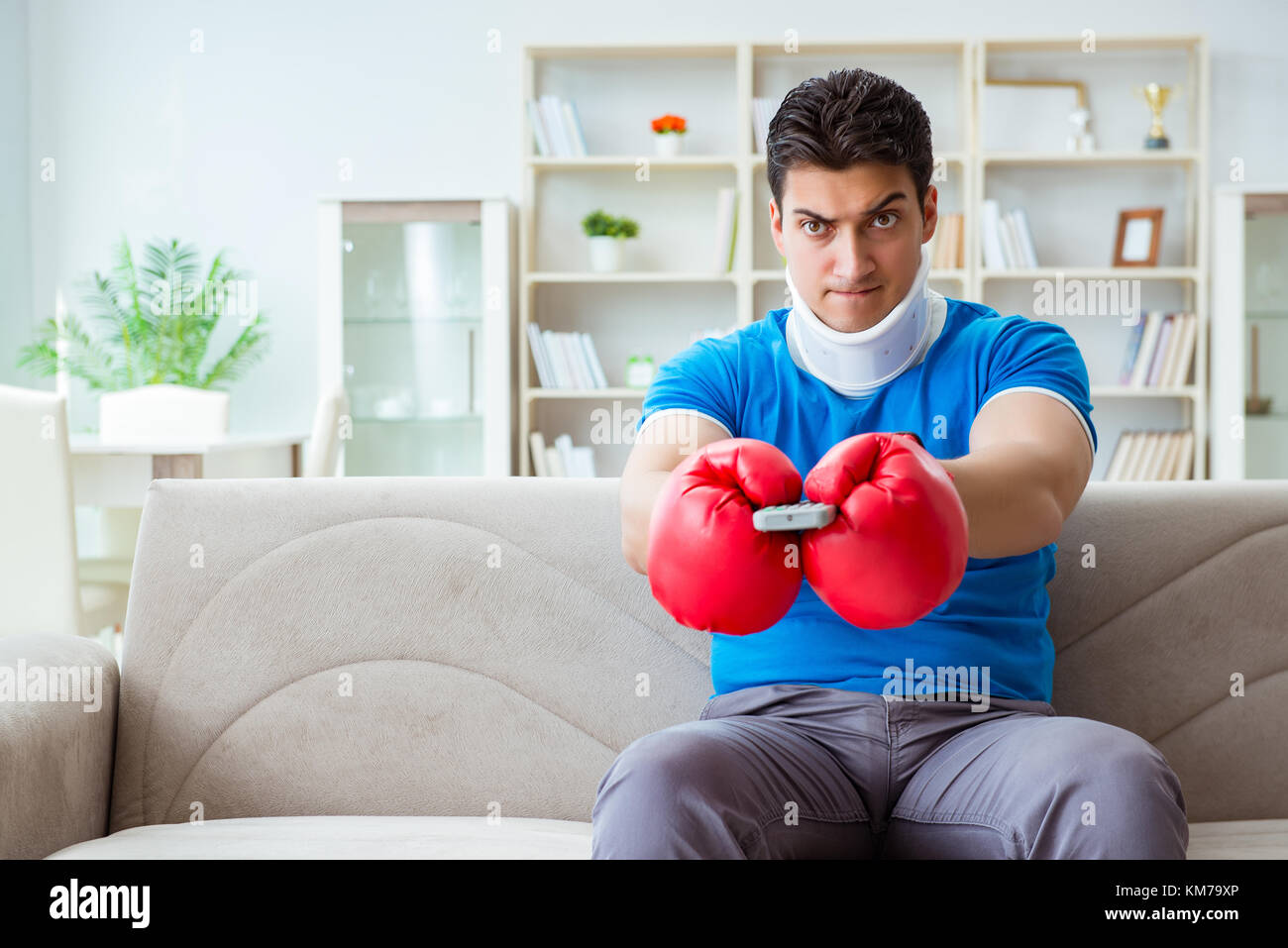 Man with neck injury watching boxing at home Stock Photo - Alamy