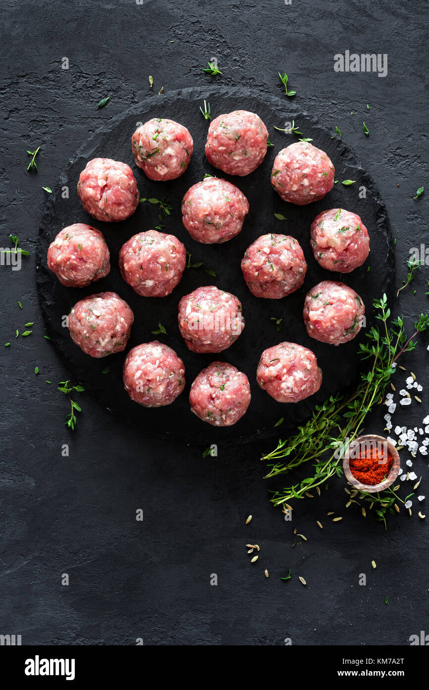 Raw meatballs on dark background, top view Stock Photo - Alamy